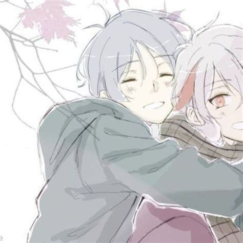 Two People Hugging Each Other In Front Of A Tree