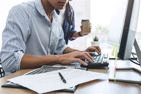 two professional programmers cooperating at developing programming and website working in a