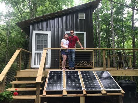 Two People Standing On A Deck With Solar Panels