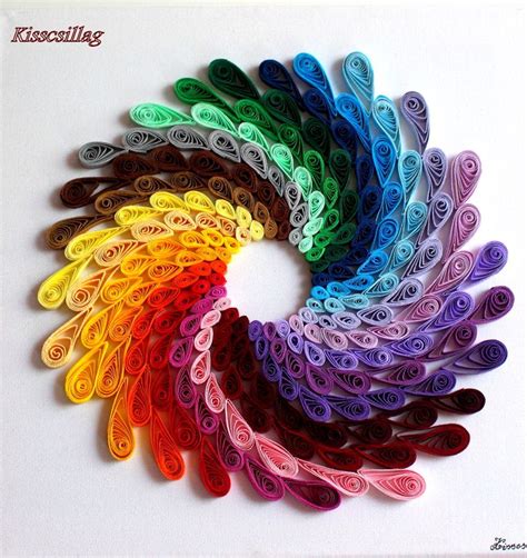 Colorful Paper Quillings Arranged In A Circle On A White Surface With