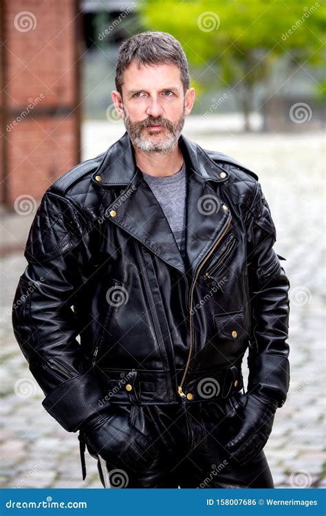 Handsome Bearded Man Wearing A Black Leather Jacket And Pants Stock