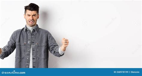 Disgusted Guy Showing Big Size Object And Grimacing From Dislike And