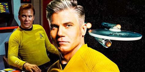 Two Men Sitting At A Table In Front Of A Star Trek Ship With The