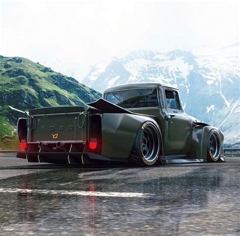An Old Truck Is Parked On The Road In Front Of Some Mountains And Snow