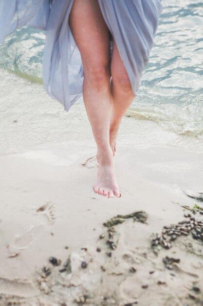 Premium Photo Low Section Of Woman Standing On Beach