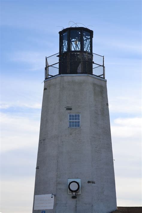 A Light House Sitting On Top Of A Hill