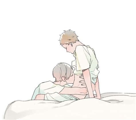 Two People Sitting On Top Of A Bed With White Sheets And One Person