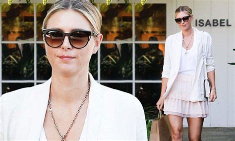A Woman Wearing Sunglasses And A White Dress