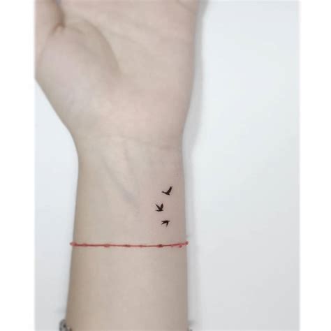 Minimalistic Style Flying Birds Tattooed On The Wrist