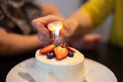 Premium Photo Decorated Birthday Fruit Cake Lighting A Candle
