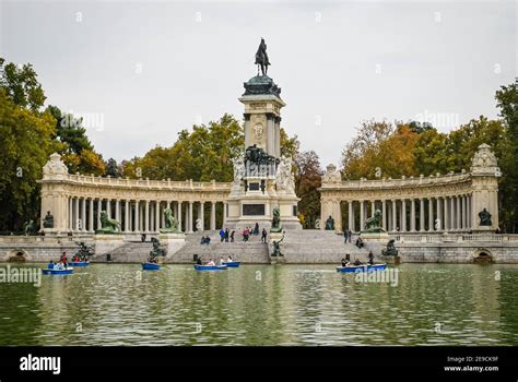 Central Pond In El Retiro Park With A Colonnaded Monument Popular For