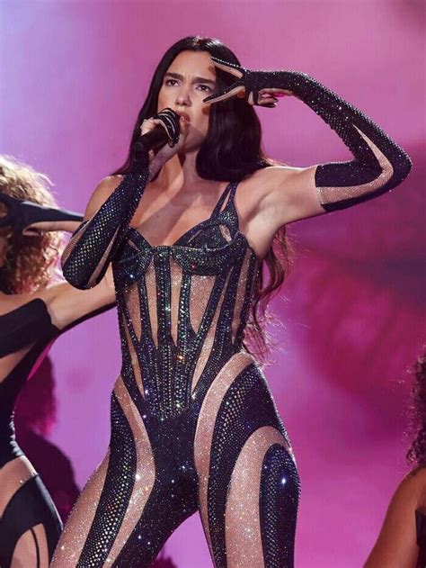 Two Women In Bodysuits On Stage With One Holding Her Hair Up To The Side