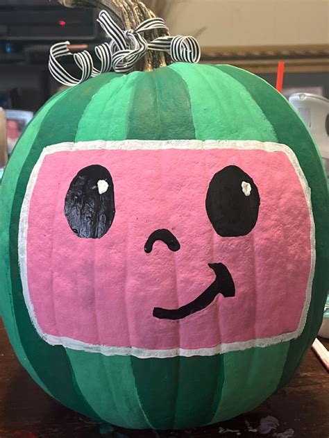 A Watermelon Painted Like A Face On A Table