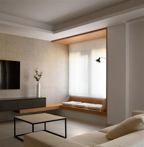 A Living Room Filled With Furniture And A Flat Screen Tv Mounted On A