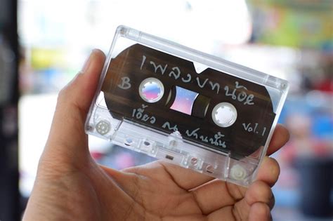Premium Photo Close Up Of Person Hand Holding Audio Cassette