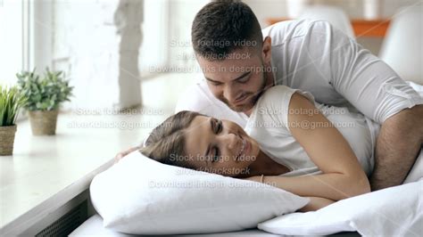 Young Beautiful And Loving Couple Wake Up At The Morning Attractive Man Kiss And Hug His Wife