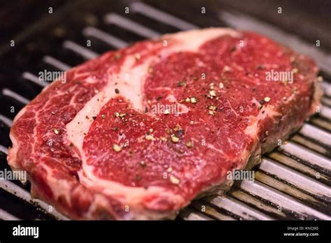 A Rib Eye Steak Cooking On A Griddle Pan Stock Photo Alamy