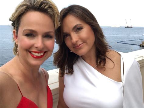 Two Women Standing Next To Each Other In Front Of The Ocean On A Cruise