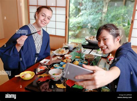 Caucasian Woman Wearing Yukata With Japanese Friend At Traditional