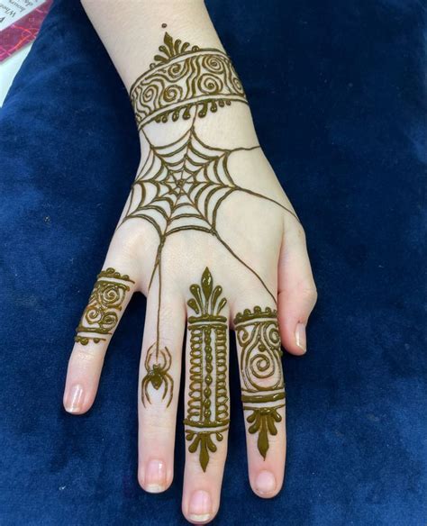 A Woman S Hand With Henna Tattoos On It