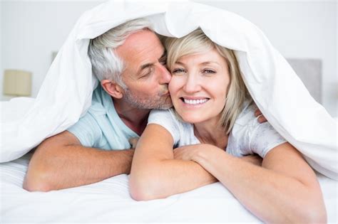 Premium Photo Closeup Of Mature Man Kissing Womans Cheek In Bed