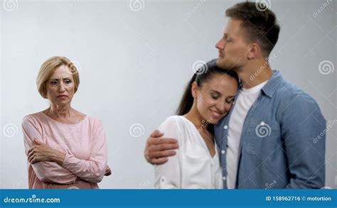 Lonely Mother Looking At Daughter Hugging Husband Lack Of Attention