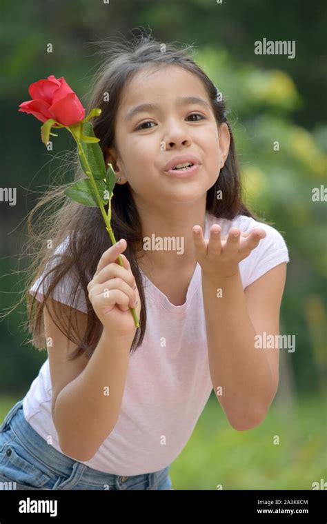 Petite Filipina Female Blowing A Kiss With A Rose Stock Photo Alamy