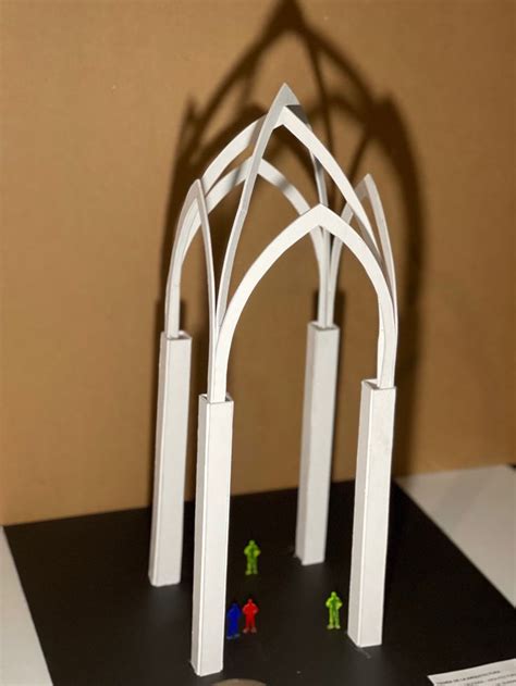 A Paper Model Of An Arch With People Standing In Front Of It On Top Of