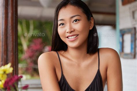 Dreamy Content Delighted Chinese Female Model Has Pleased Expression