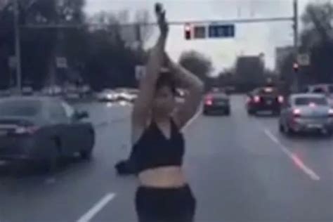 Bizarre Moment Woman Strips In Middle Of Road And Dances For Cars In