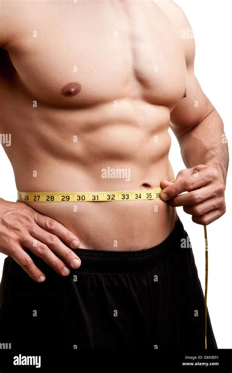 Fit Man Measuring His Waist After A Workout In The Gym Isolated In A
