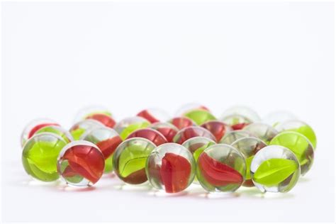 Premium Photo Close Up Of Marbles Over White Background