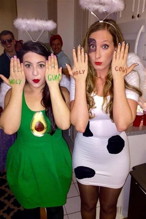 Two Women Dressed In Costumes Holding Their Hands Up With Words Painted