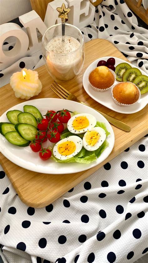 Two Plates With Eggs Cucumbers And Tomatoes On Them Sitting On A Table