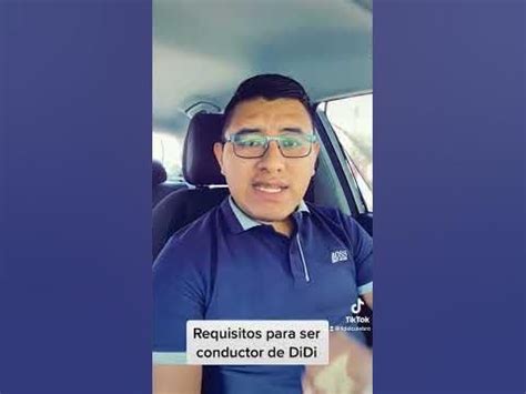A Man Sitting In The Back Seat Of A Car Wearing Glasses And Pointing At