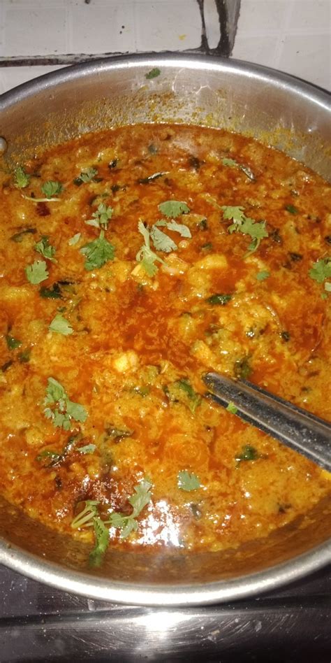 A Pan Filled With Food Sitting On Top Of A Stove