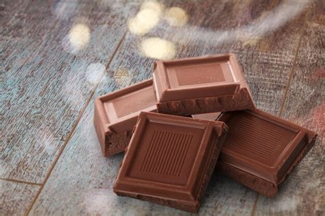 Premium Photo Close Up Of Chocolate Pieces Stack Falling
