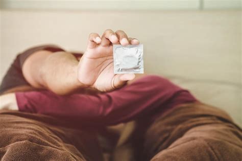 Premium Photo Low Section Of Man Holding Condom