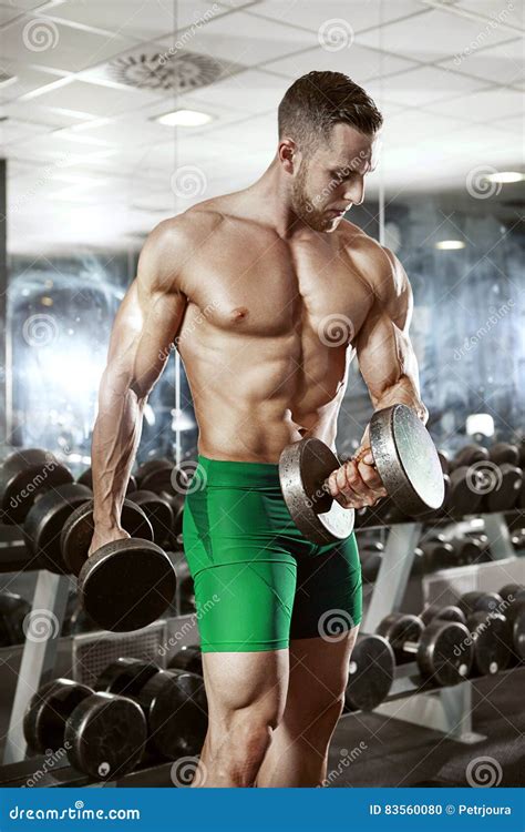 Muscular Bodybuilder Guy Doing Exercises With Dumbbell Stock Photo