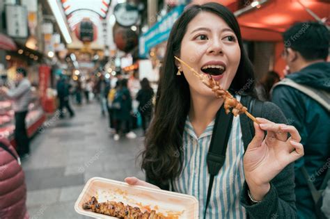 Premium Photo Joyful Woman Experience Local Japanese Culture Eating Tasty Yakitori Cheerful
