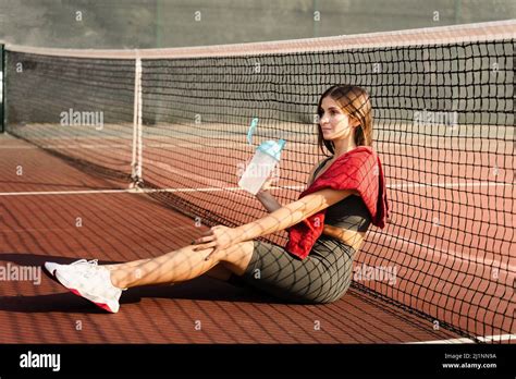 Athletic Fit Asian Girl Drinking Water From A Bottle Rest After Training On The Tennis Court