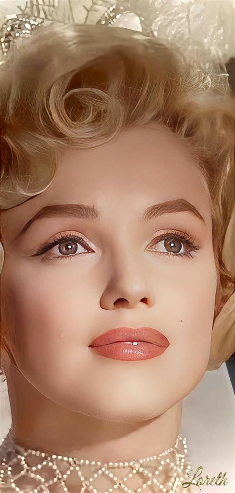 A Woman With Blonde Hair And Pearls On Her Head