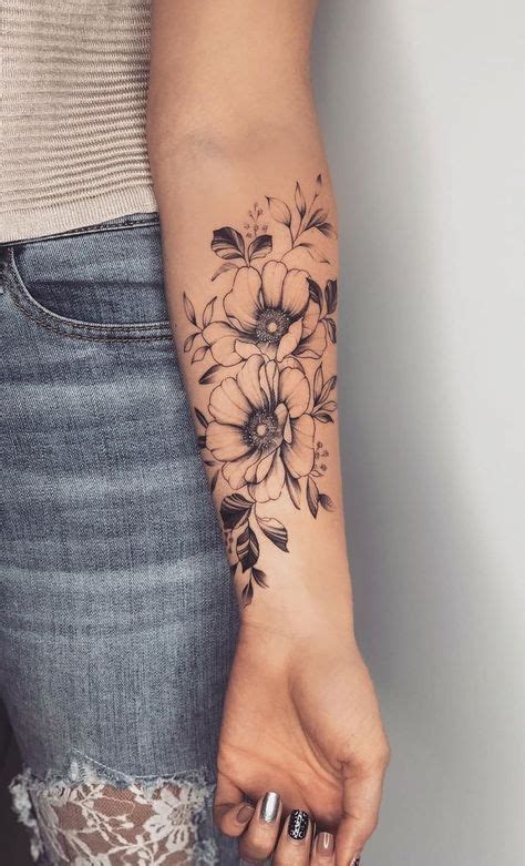 A Woman S Arm With Black And White Flowers Tattooed On The Left Side Of