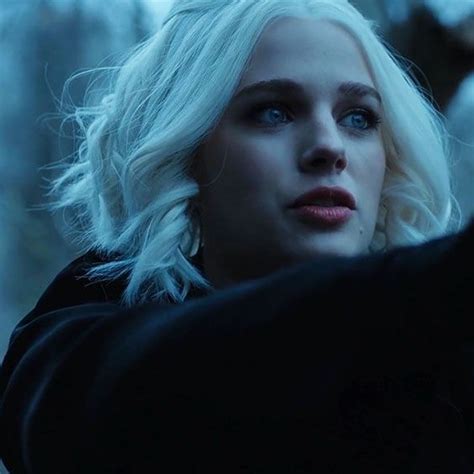 A Woman With Blonde Hair And Blue Eyes Is Pointing Her Finger At