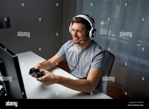 Man In Headset Playing Computer Video Game At Home Stock Photo Alamy