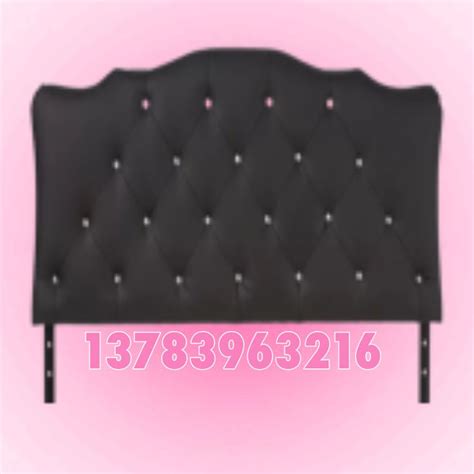A Black Headboard With Studded Buttons On The Top And Bottom Against A