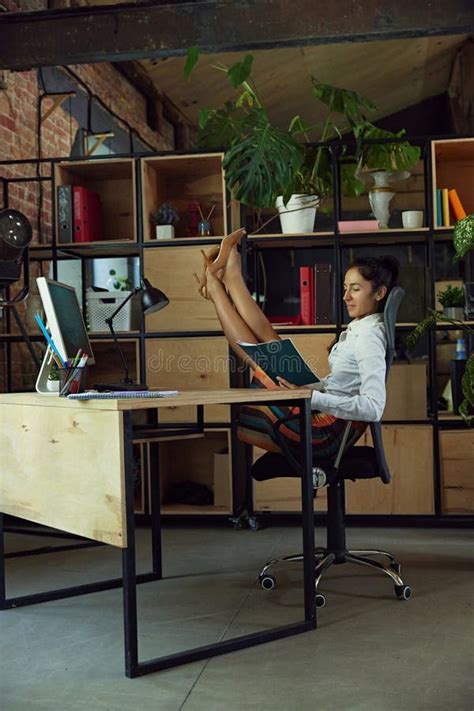 Woman Employee In Modern Office Working With Computer While Doing