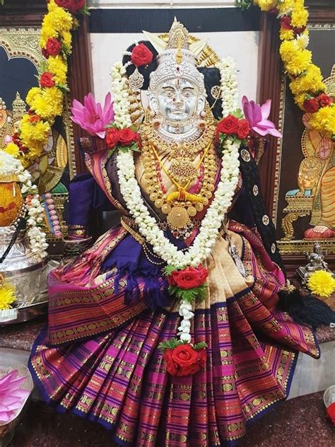 The Statue Is Decorated With Flowers And Garlands