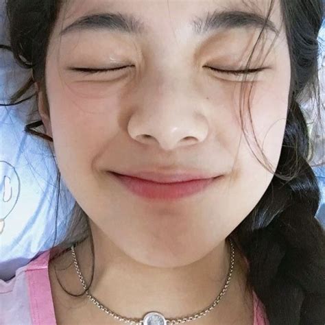 A Close Up Of A Person Wearing A Necklace
