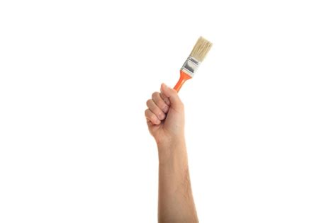 Mano Sosteniendo Un Pincel Sobre Fondo Blanco Foto Premium